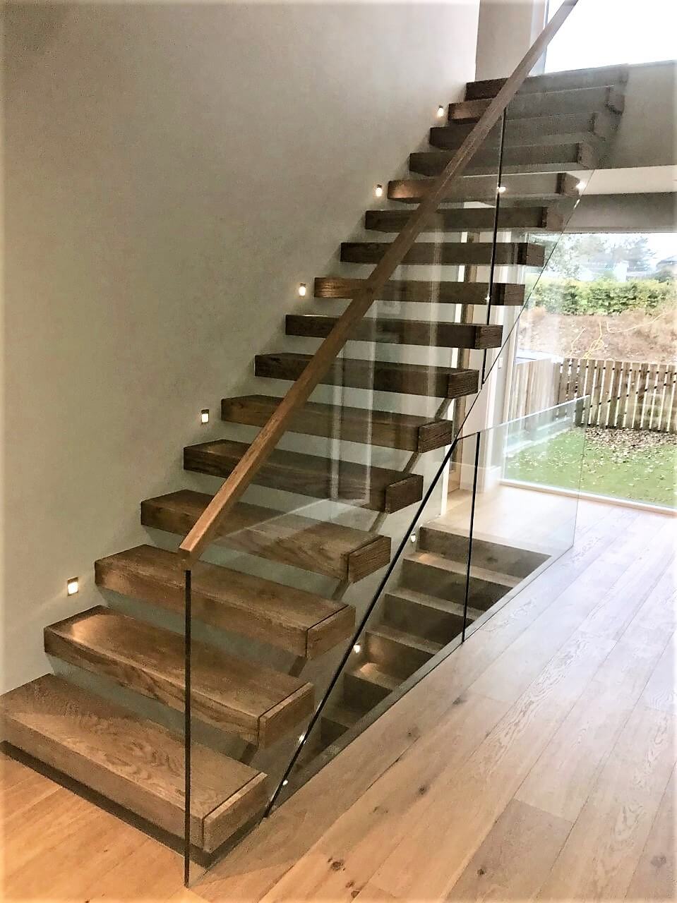 Dark oak floating stairs with glass balustrade and LED lighting ...