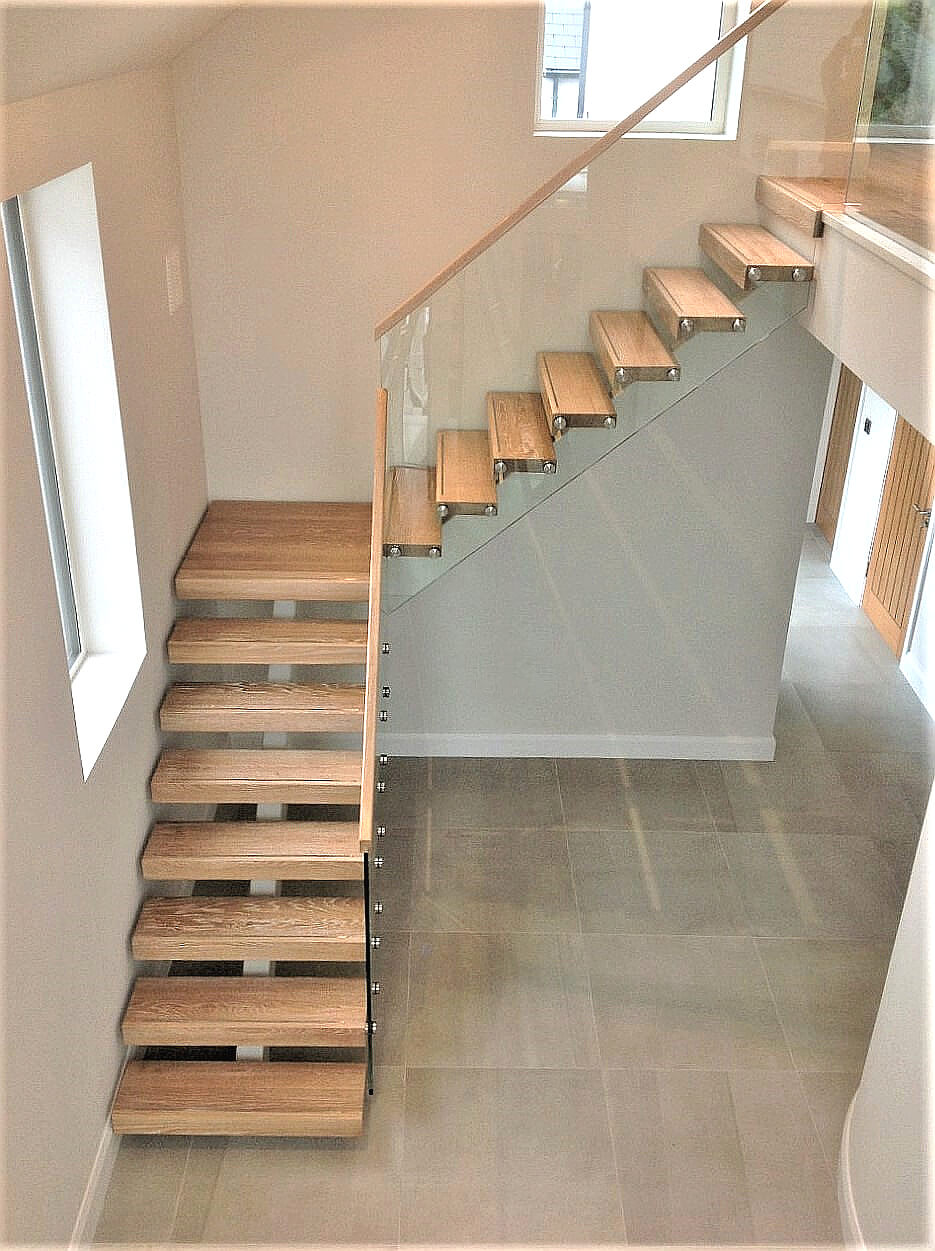 Ivory steel spine stairs with glass balustrade - Manufactured and ...