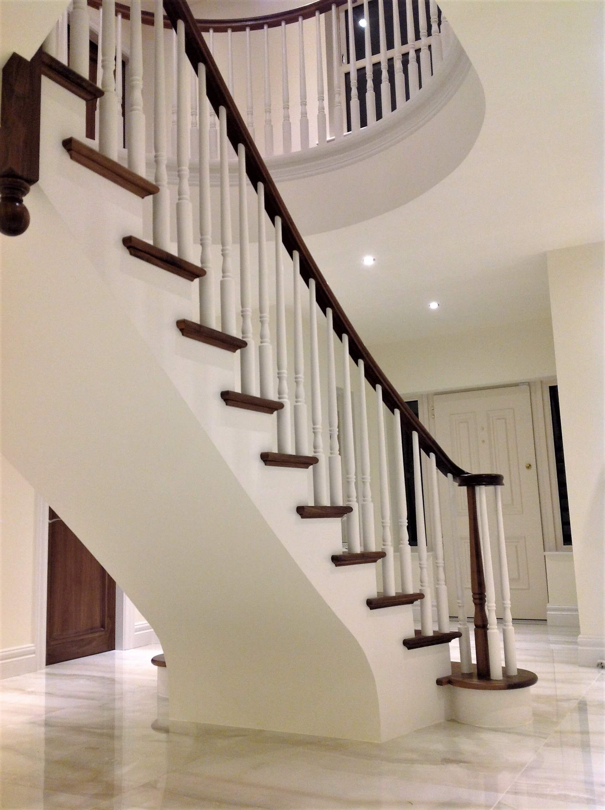 Flared walnut and ivory stairs with curved landing - Concrete flared ...