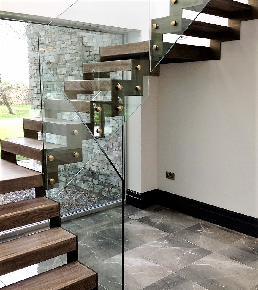 Stepped soffit steel string stairs with glass balustrade